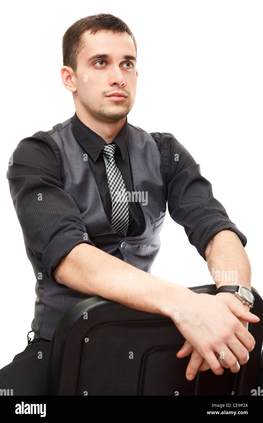 Portrait of young Caucasian smart business man sitting on chair ...