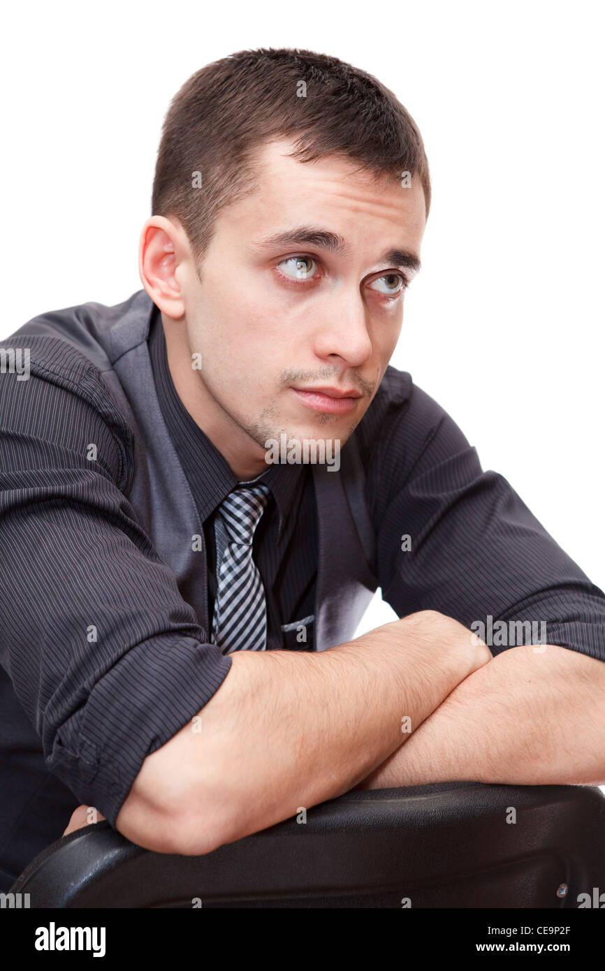 Portrait of young Caucasian smart business man sitting on chair ...