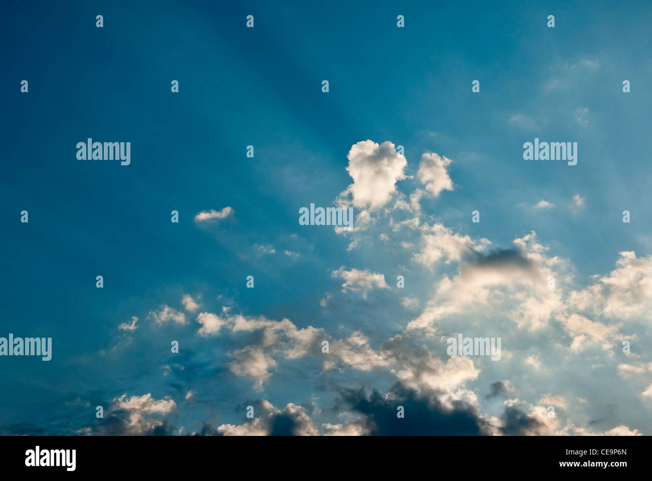 Sun streaming beams from behind clouds Stock Photo - Alamy