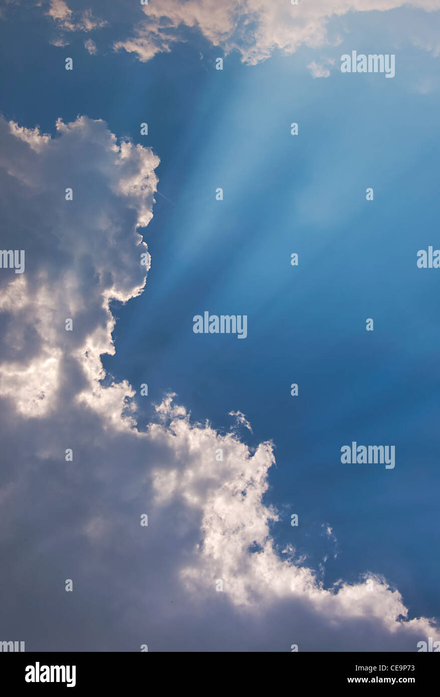 Sun streaming beams from behind clouds Stock Photo - Alamy