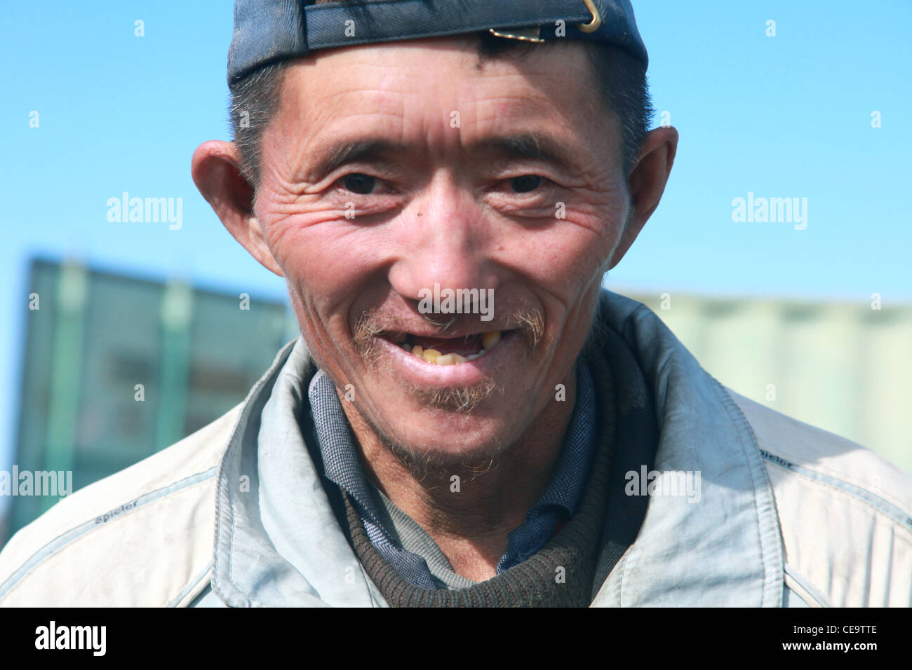 The man Mongolian closeup smiling at the camera Stock Photo - Alamy