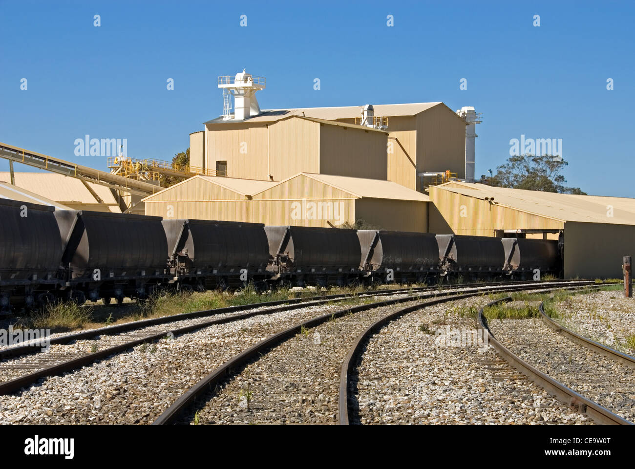 Rolling stock parked on a siding beside a limestone crushing factory in ...