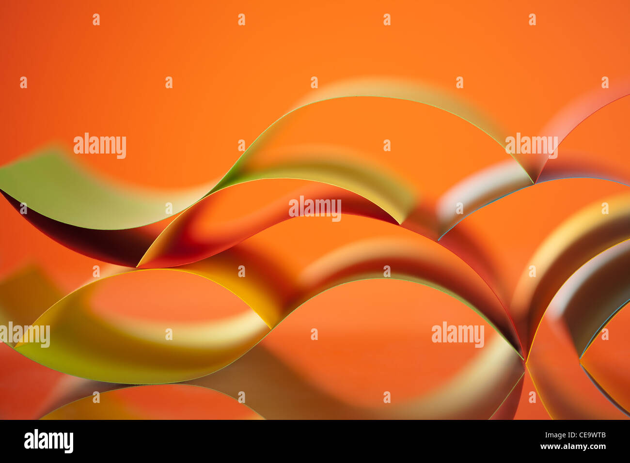 background image of colorful origami pattern made of curved sheets of ...