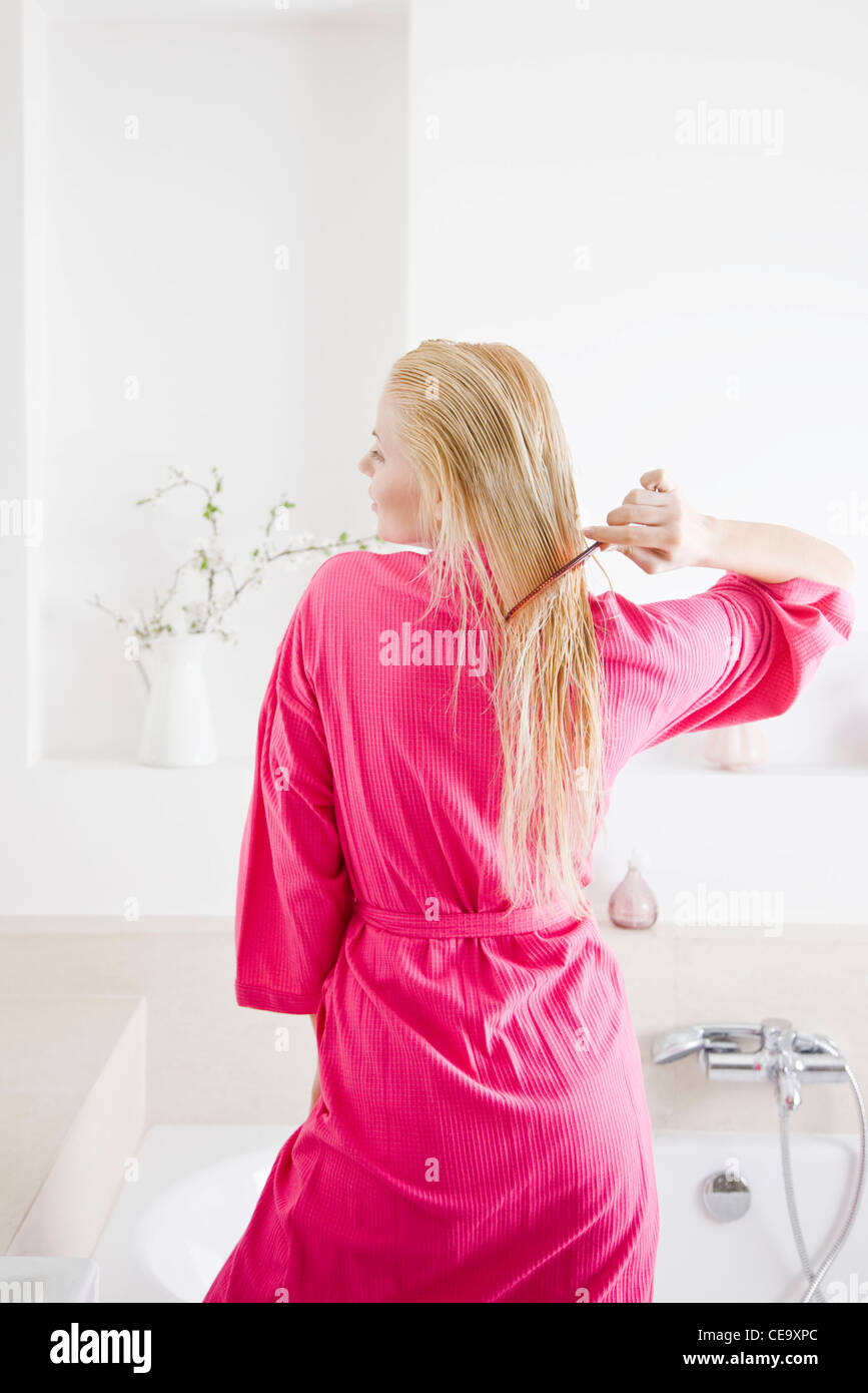 Woman combing hair Stock Photo - Alamy