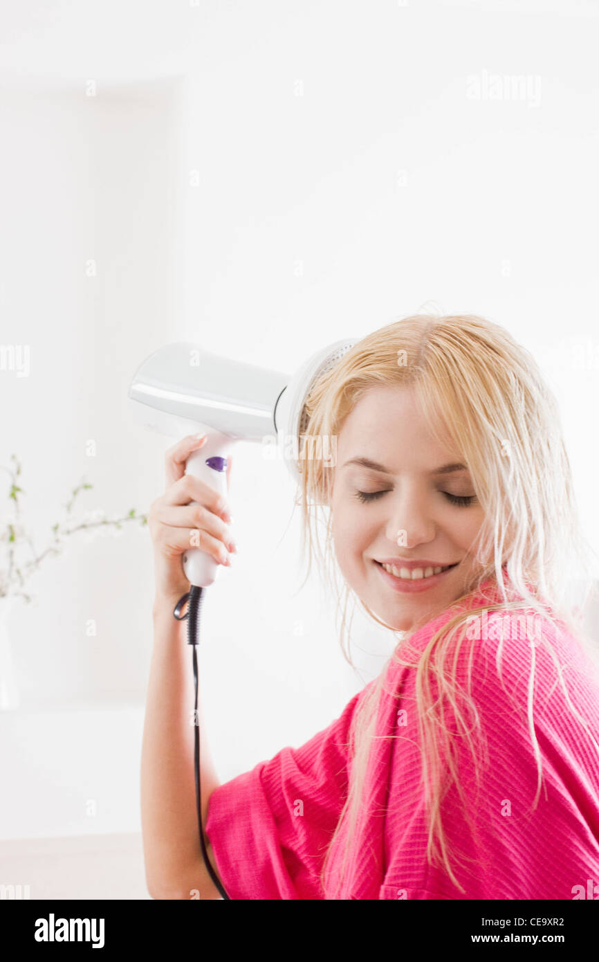 Woman drying hair Stock Photo - Alamy