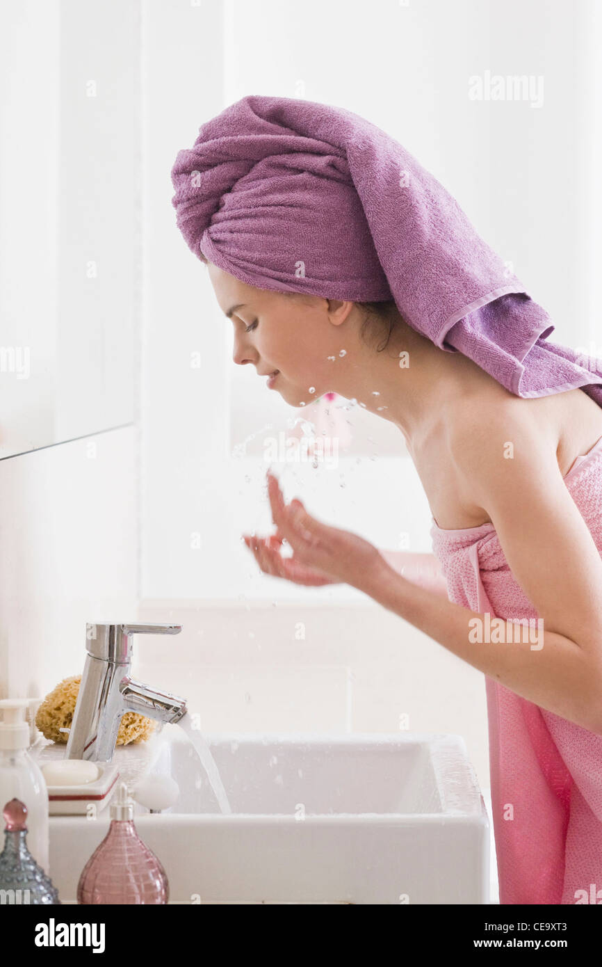 Woman washing face Stock Photo - Alamy