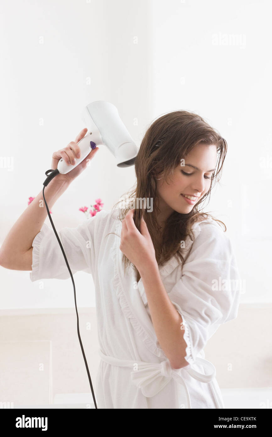 Woman drying hair Stock Photo - Alamy