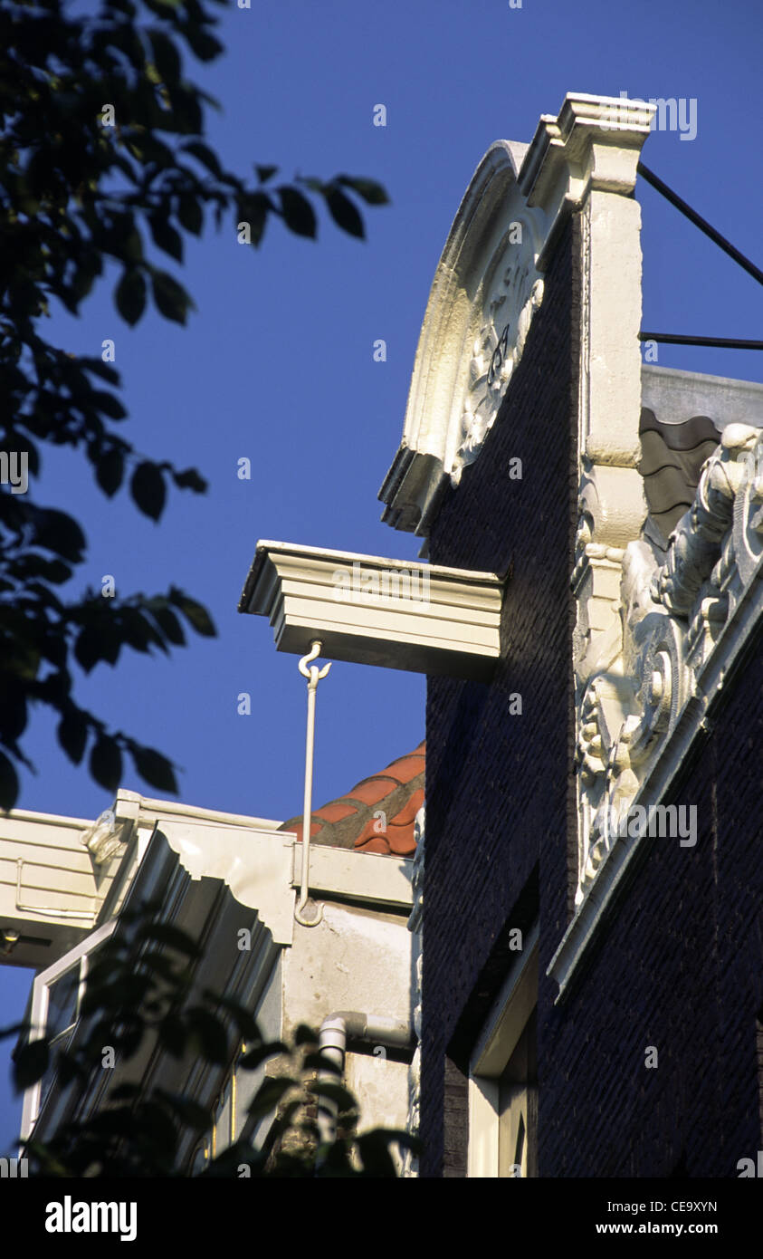 Hooks and beams are used for hoisting furniture on old Dutch buildings ...
