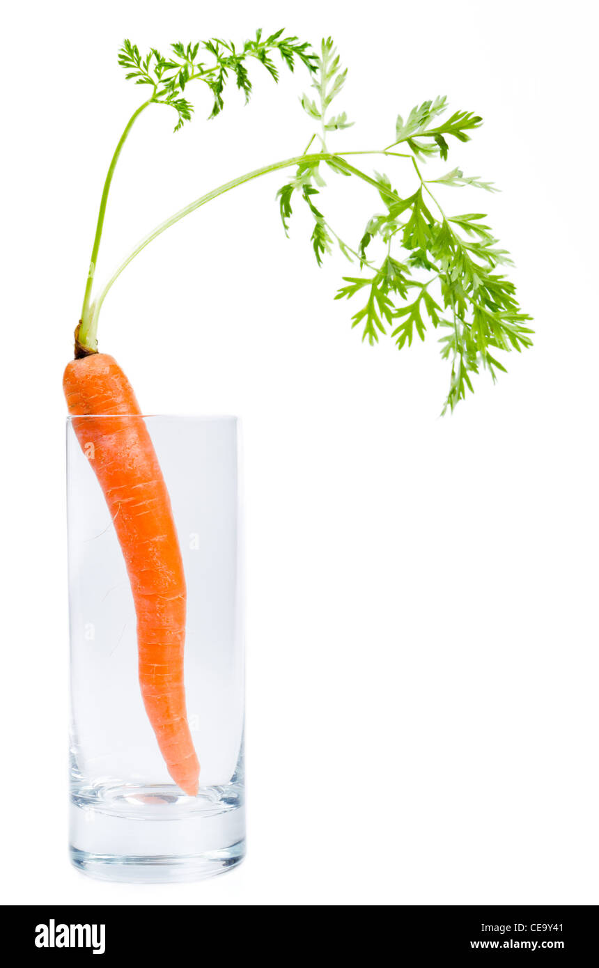 a carrot stands in a glass before white background Stock Photo - Alamy