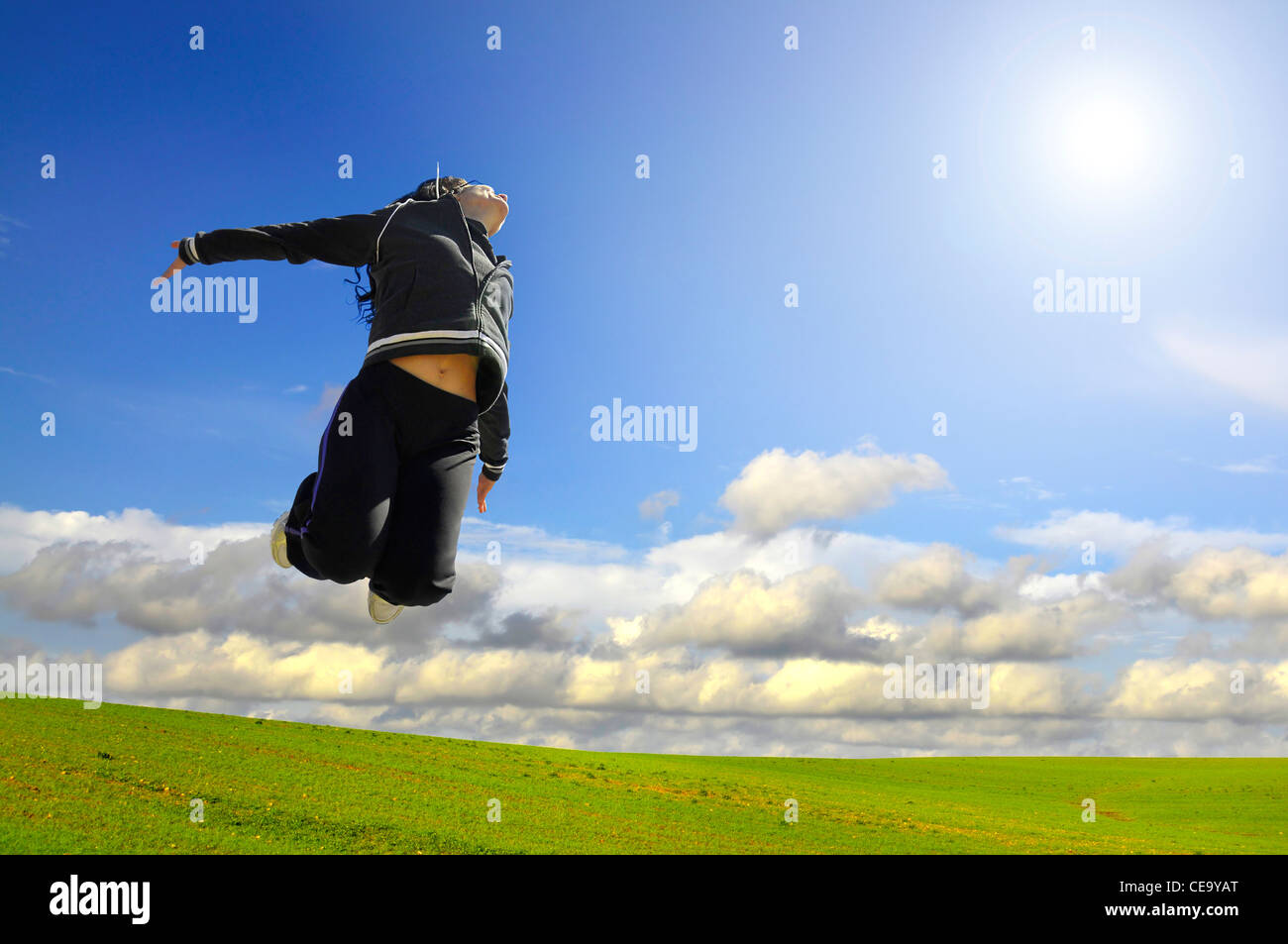 Woman jumping high in a green field Stock Photo - Alamy