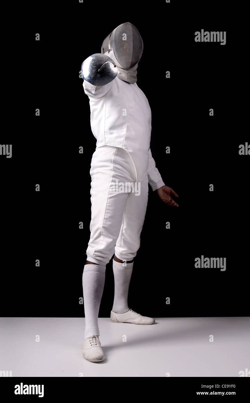 Male fencer isolated in a dark background Stock Photo - Alamy