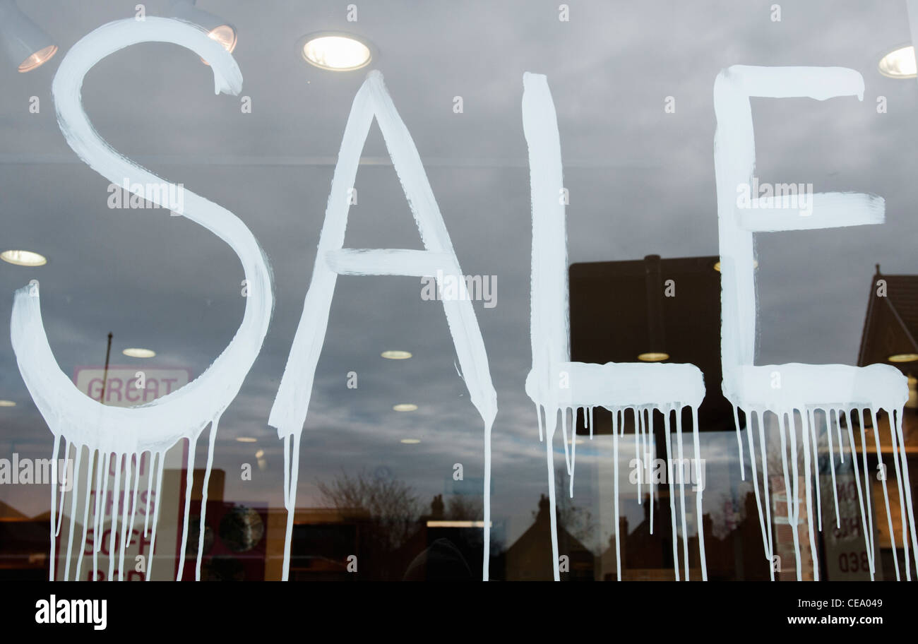 ENGLAND, UK - Sale sign painted on the inside of a shop window ...