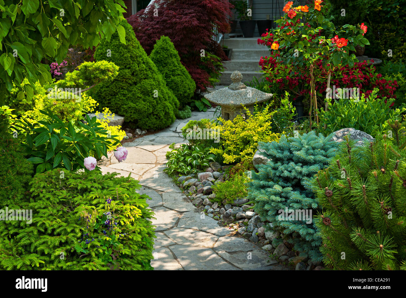 Natural flagstone path landscaping in home garden Stock Photo - Alamy