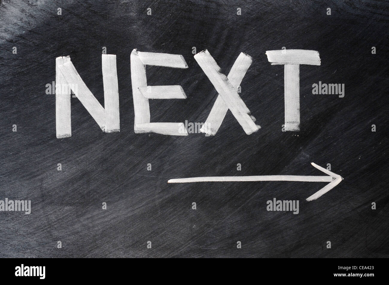 Next written on blackboard with a right arrow Stock Photo - Alamy