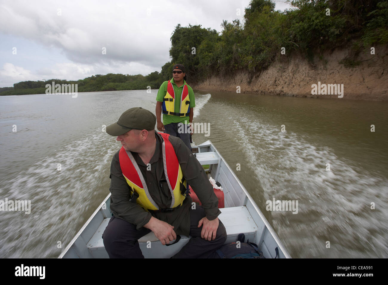 Tourist travelling in a powered boat on the Rupununi River, Guyana ...