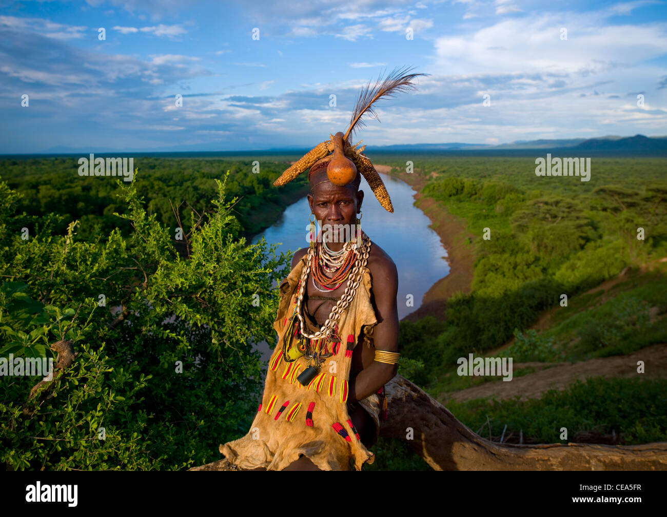 Senior Karo Woman With Headdress Made Of Corn Cob And Calabash Posing ...
