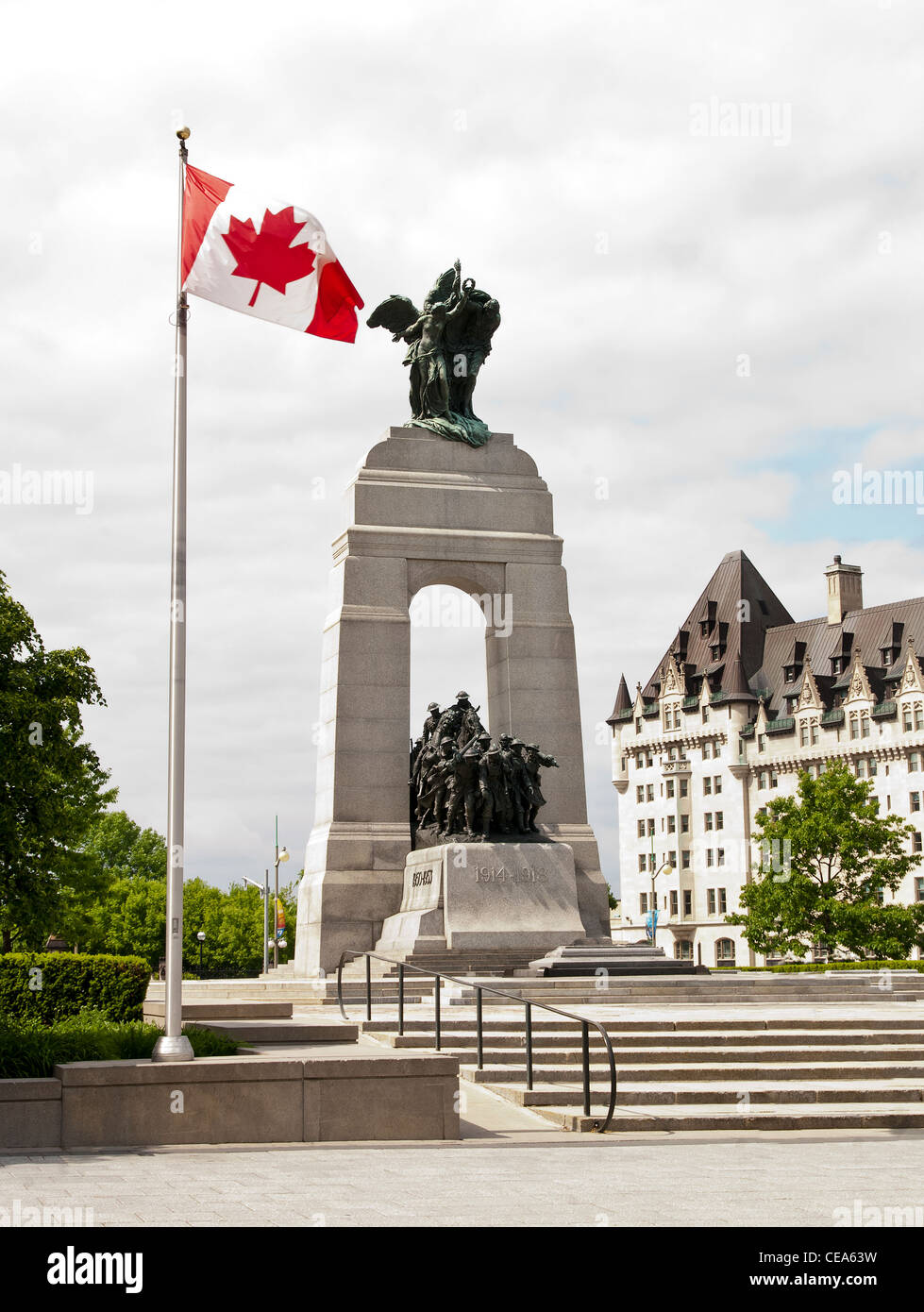 The National War Memorial with Canadian flag and the Fairmont Chateau Laurier Hotel in Ottawa ...