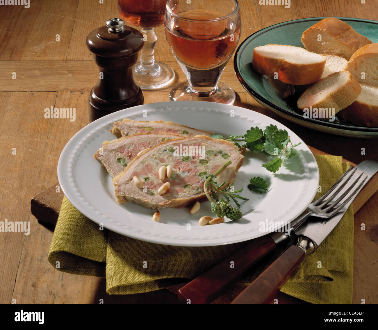 Pork belly filled with mortadella, peas, pine seeds and egg mixture ...