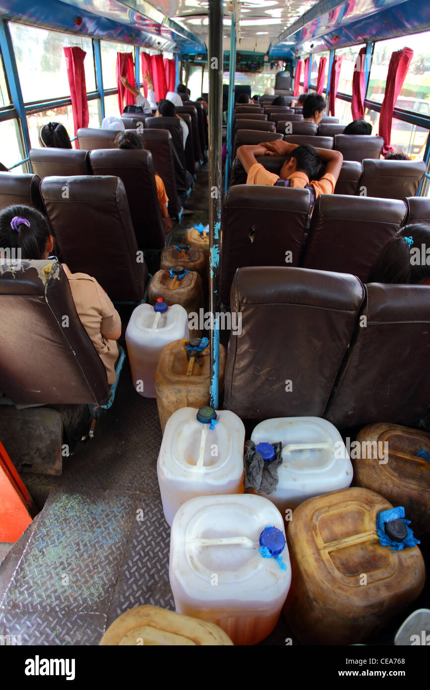 Schoolchildren on a bus loaded with plastic containers of kerosene ...