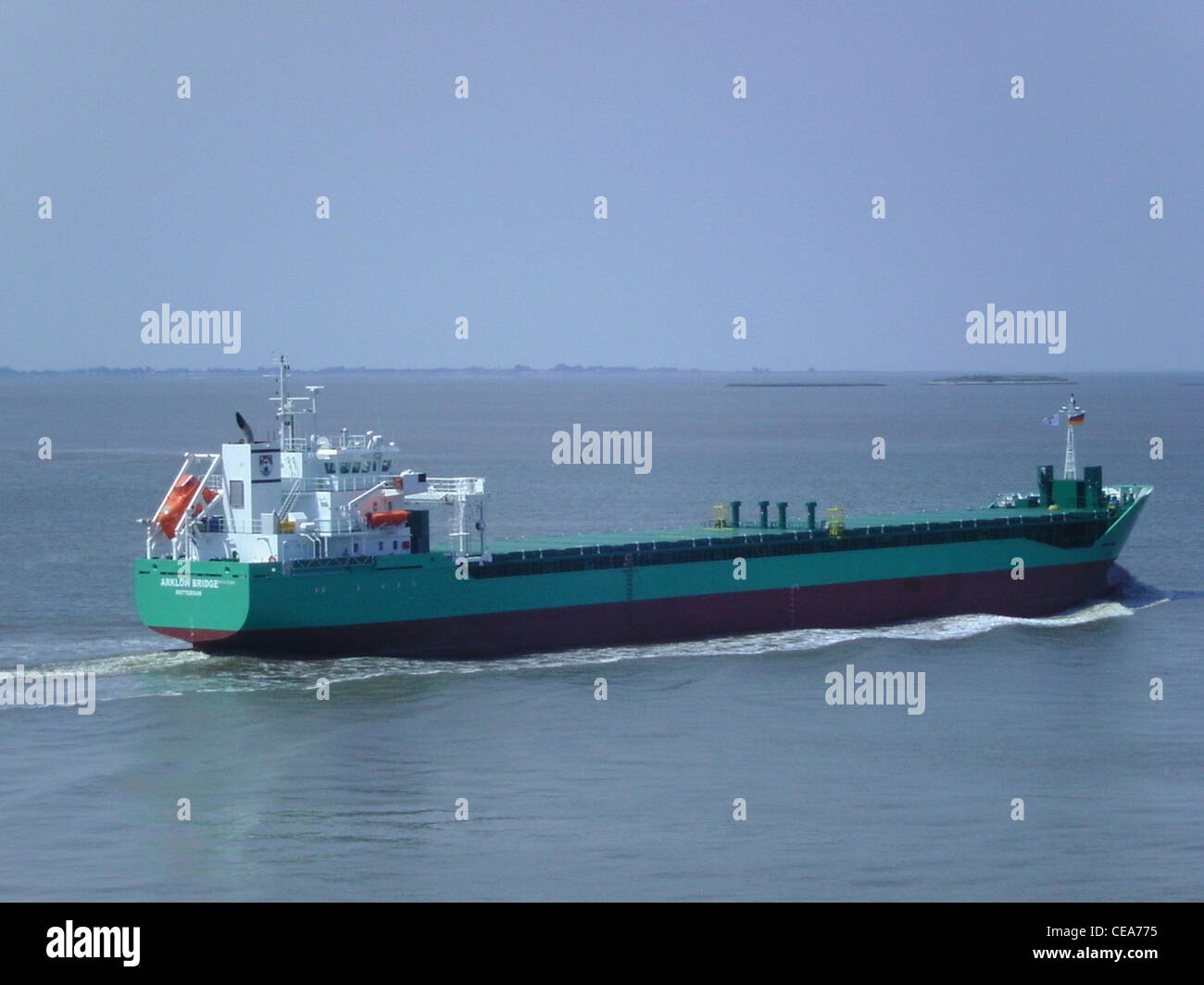 The Arklow Bridge is a cargo ship navigating the River Weser, heading ...