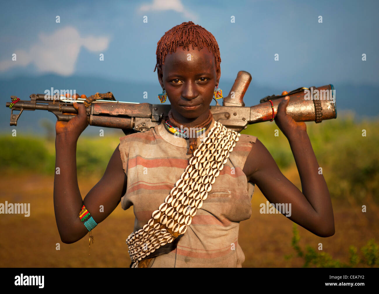 Bana Young Woman Carrying Kalashnikov Rifle On Her Shoulders Jumping ...