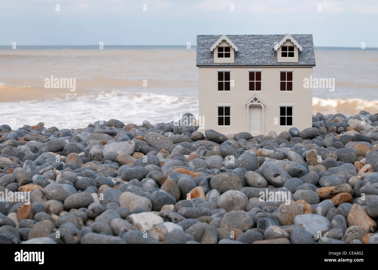 miniature dolls house on pebble beach Stock Photo - Alamy
