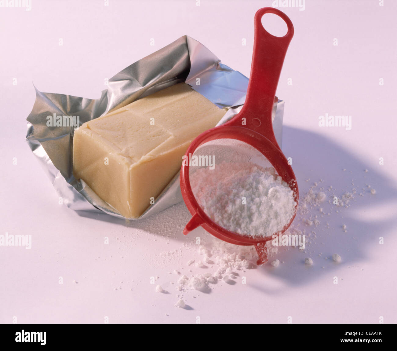 Still: almond paste and strainer with icing sugar Stock Photo - Alamy