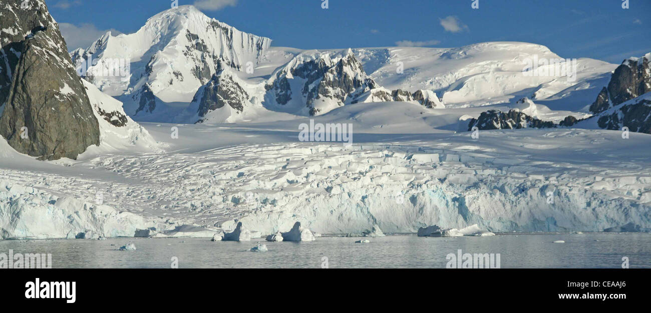 Glaciated mountains and icefall with blue sky, Lemaire Channel ...