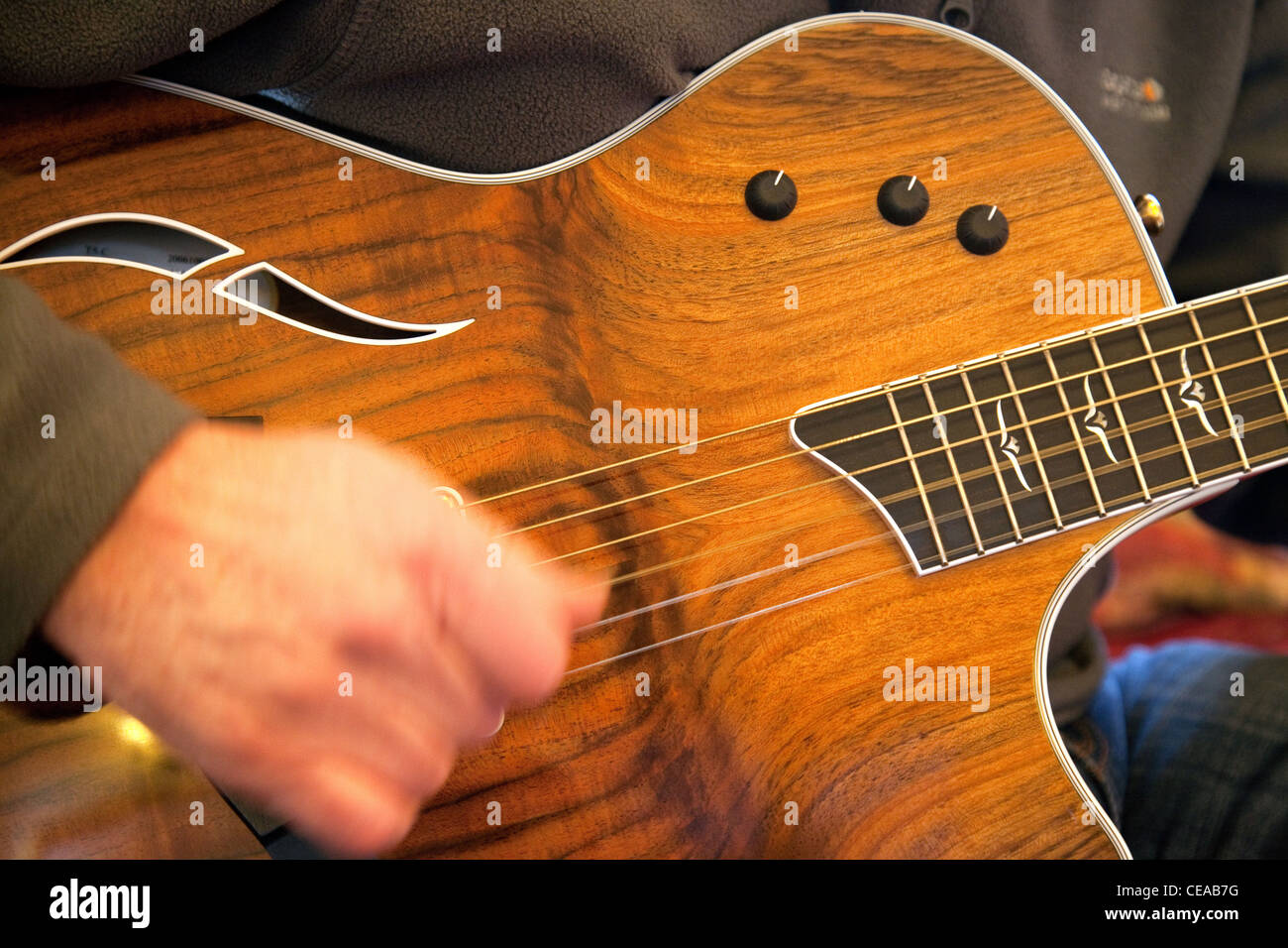 Strumming the guitar hi-res stock photography and images - Alamy