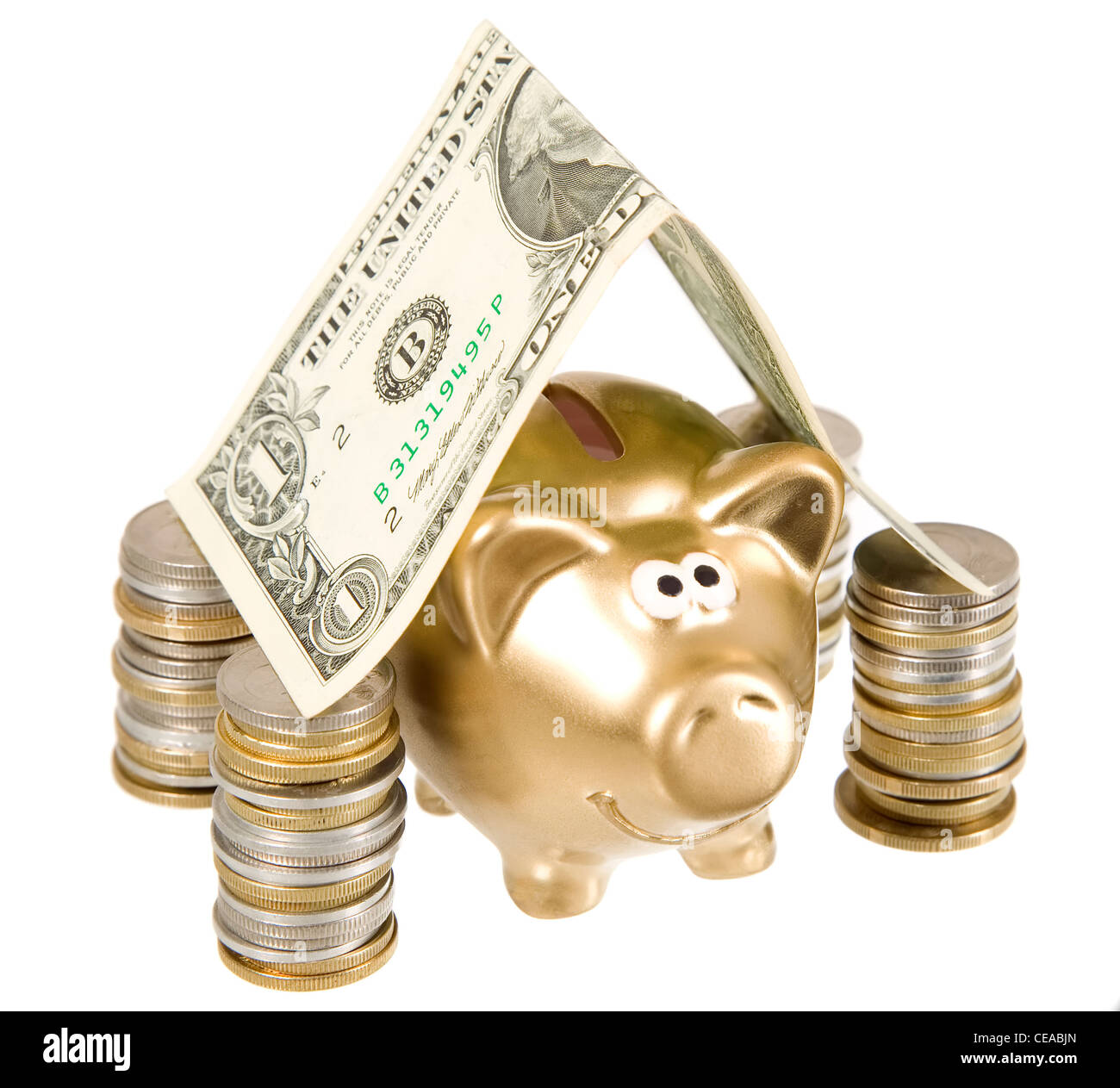 A golden moneybank under coins ant banknotes house Stock Photo - Alamy