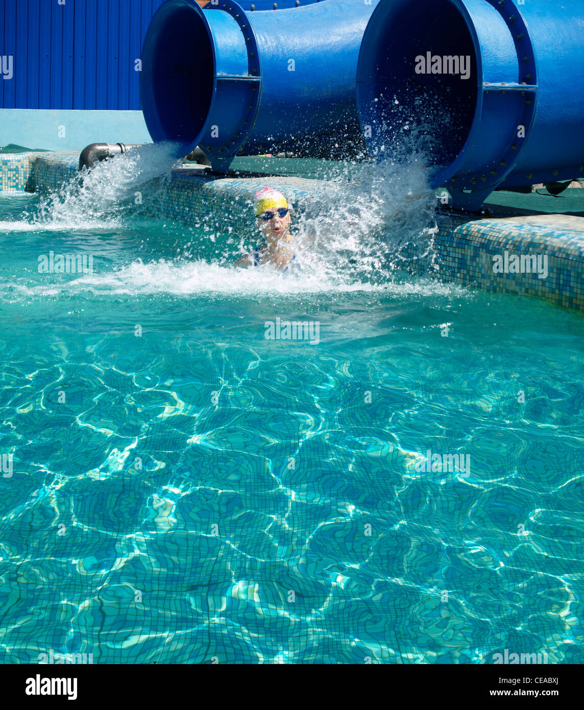 Swimming pool under the open sky with two pipes, blue water and ...