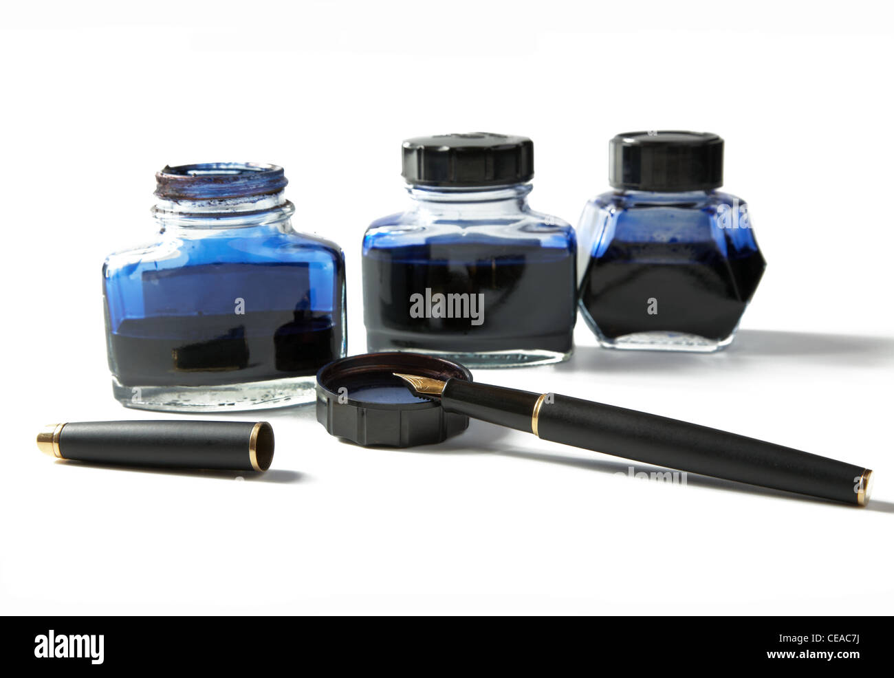 Small bottles with ink and fountain pen on a white background Stock ...
