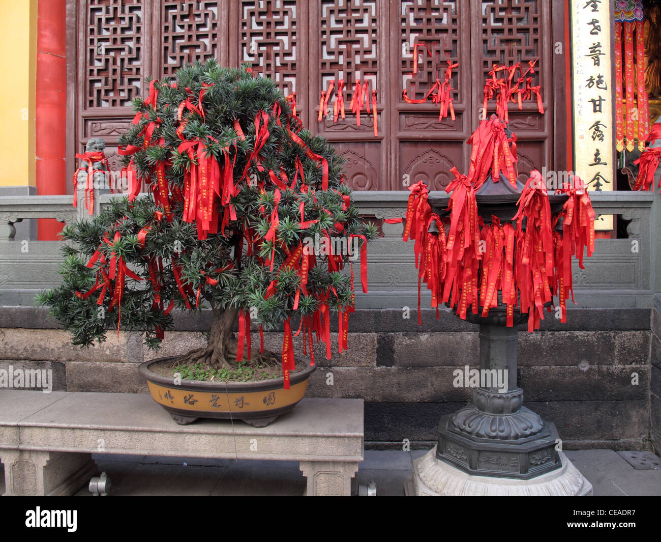Red ribbons tied for wishes, at a Buddhist temple Stock Photo - Alamy