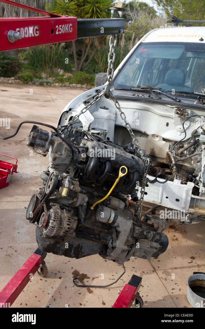 motor ripped out hanging in broken car Stock Photo - Alamy