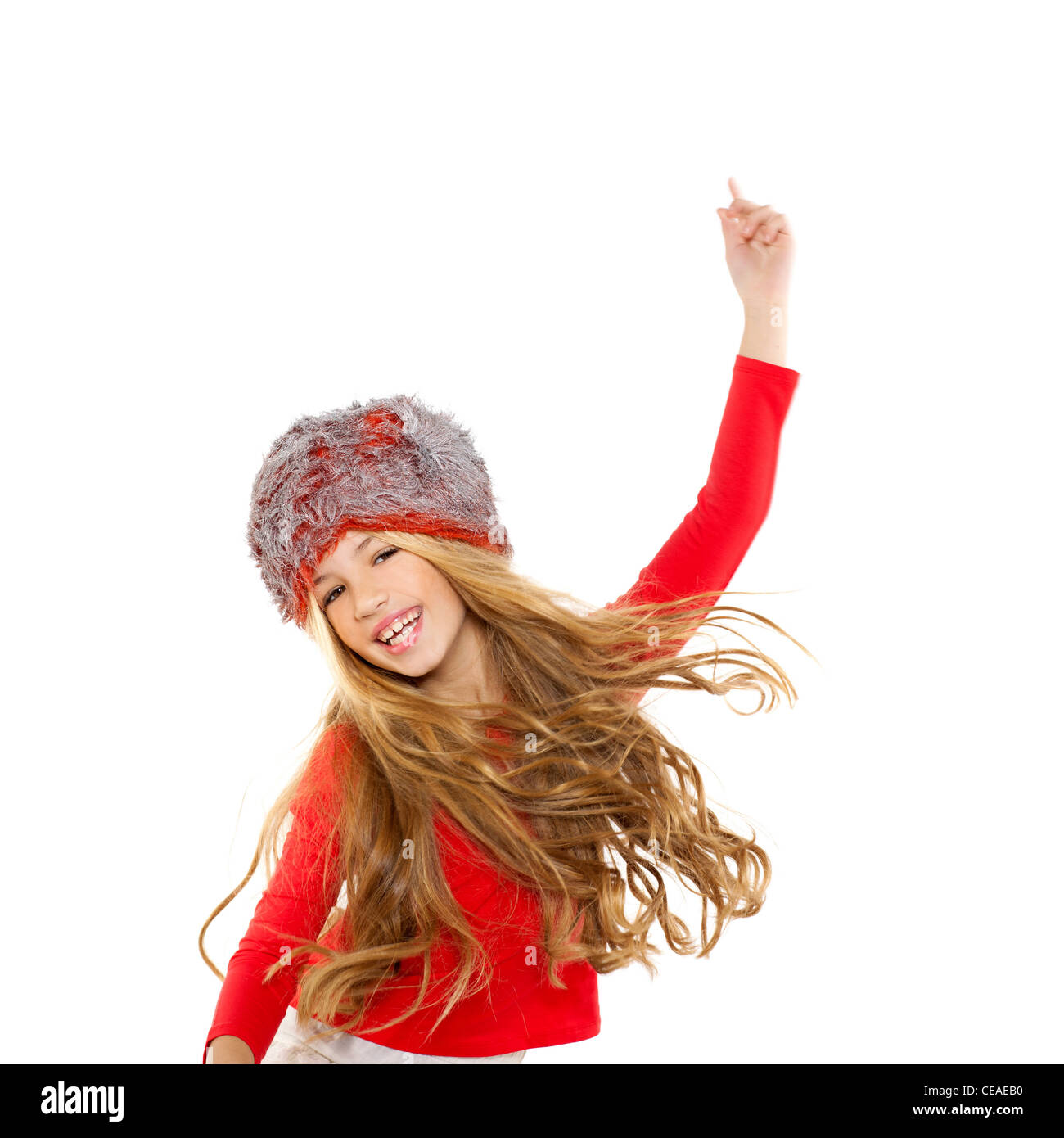 kid girl winter dancing with red shirt and fur hat on white background ...