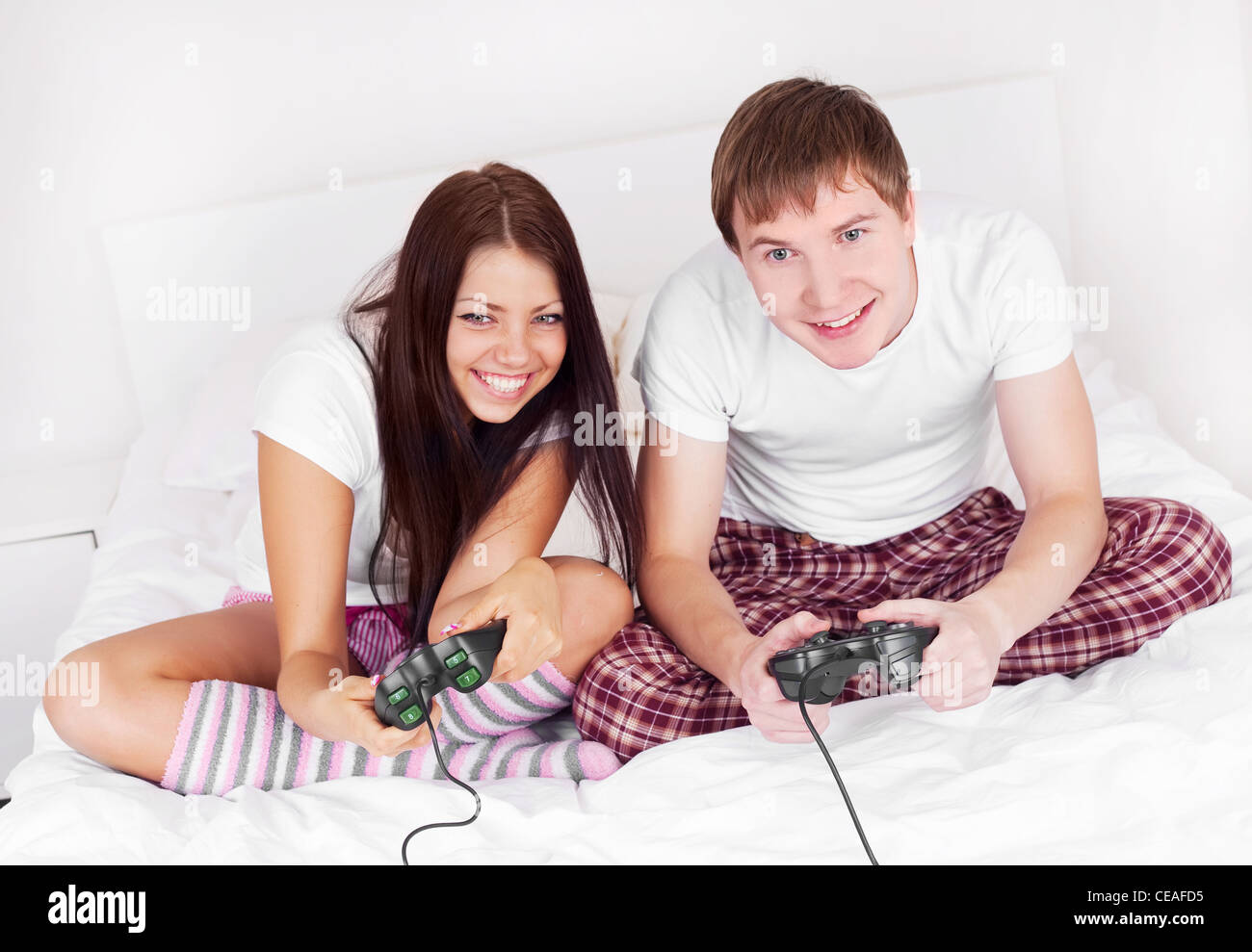 happy young teenage couple playing computer games Stock Photo - Alamy