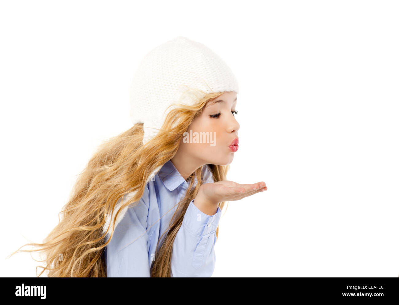beautiful winter kid girl blowing wind with lips isolated on white ...