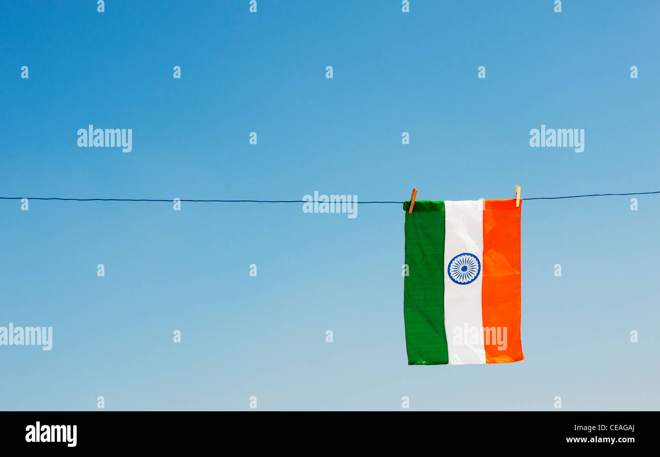 Indian flag on a washing line against a blue sky. Andhra Pradesh, India ...