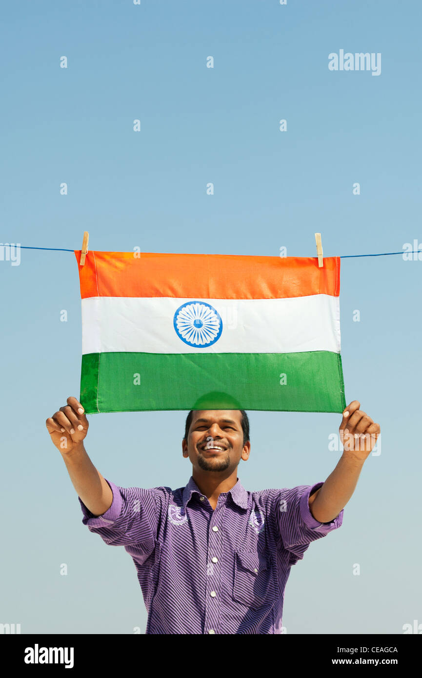 Indian man holding an Indian flag on a washing line. Andhra Pradesh ...