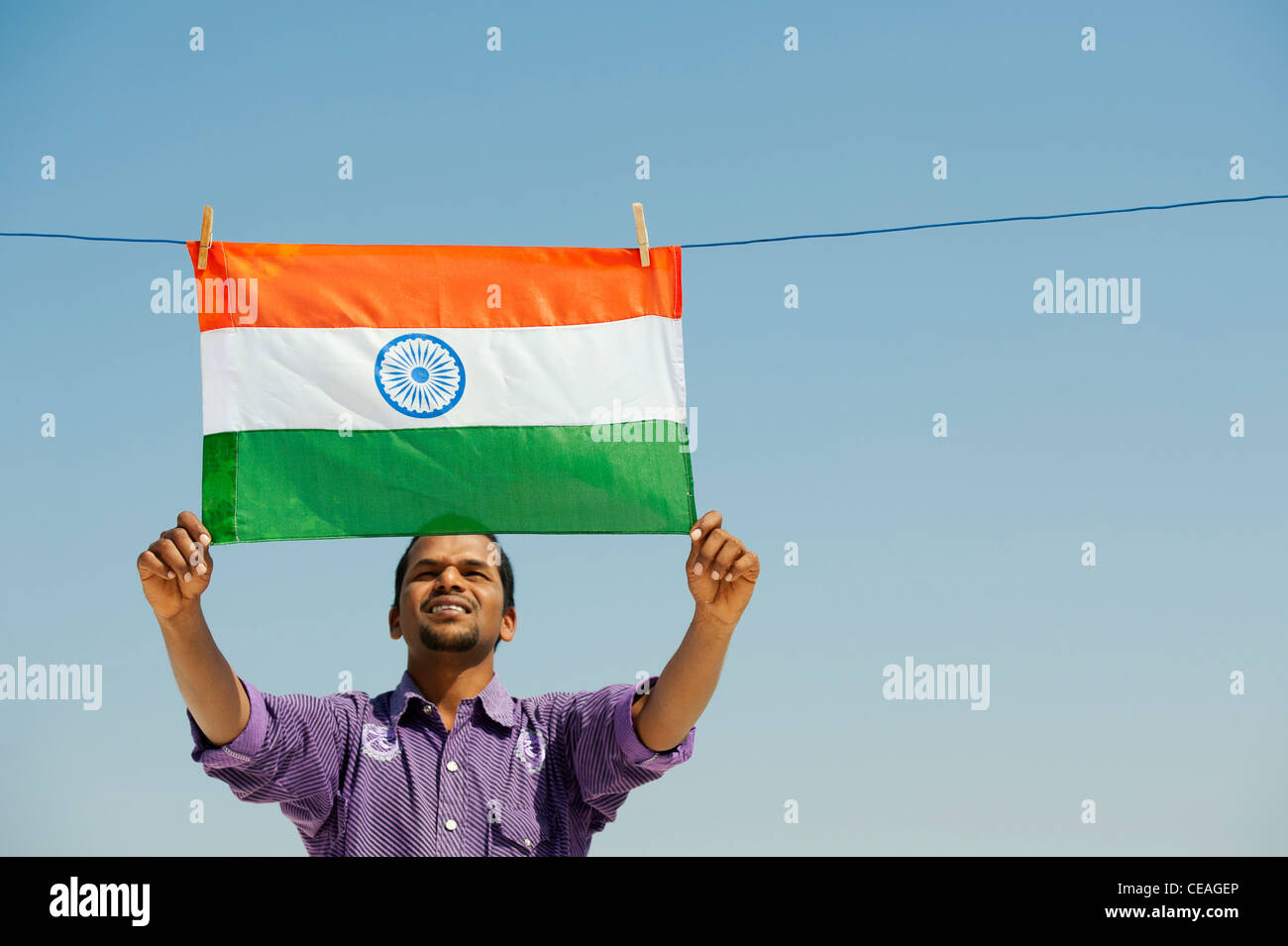 Indian man holding an Indian flag on a washing line. Andhra Pradesh ...