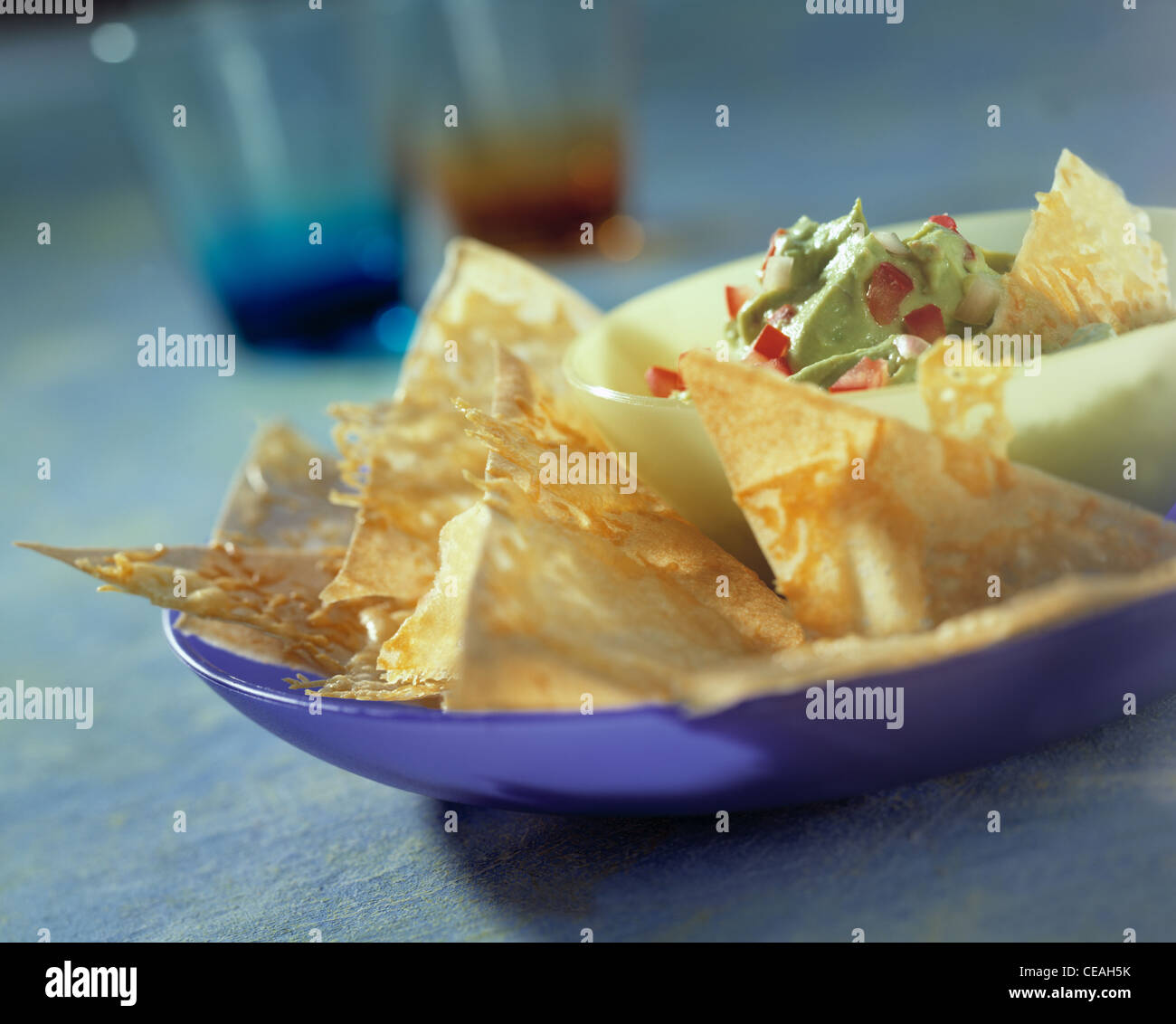 Thin parmesan cheese snacks with guacamole Stock Photo - Alamy