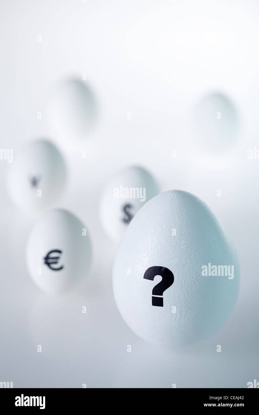 Close-up of big white egg with question mark on it among other eggs ...