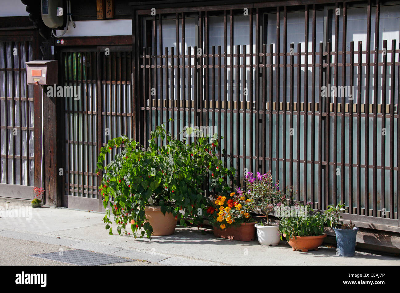 Plants displayed in front of lattice windows at Narai-juku Nagano Japan ...