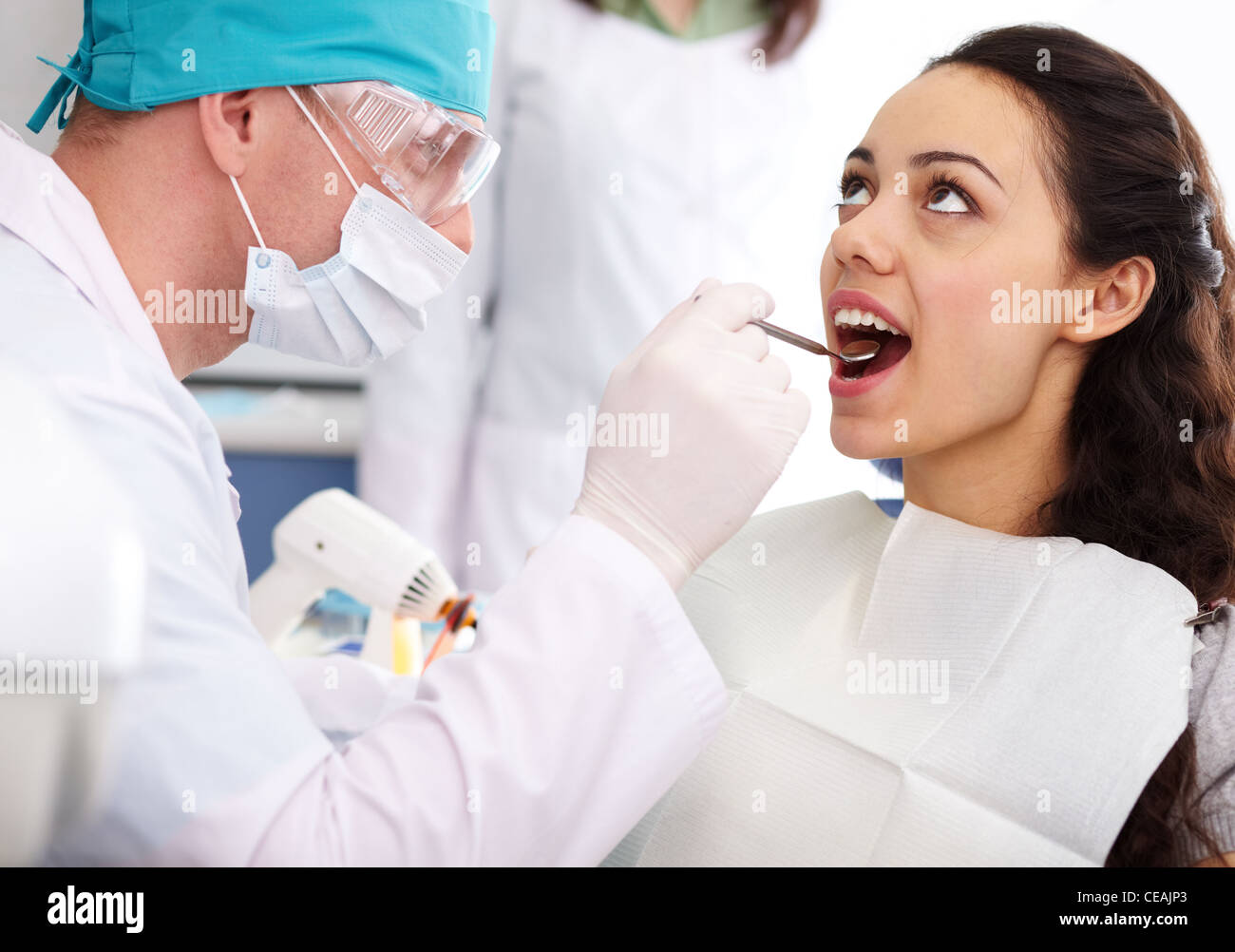 Dentist examining his patient’s teeth Stock Photo - Alamy