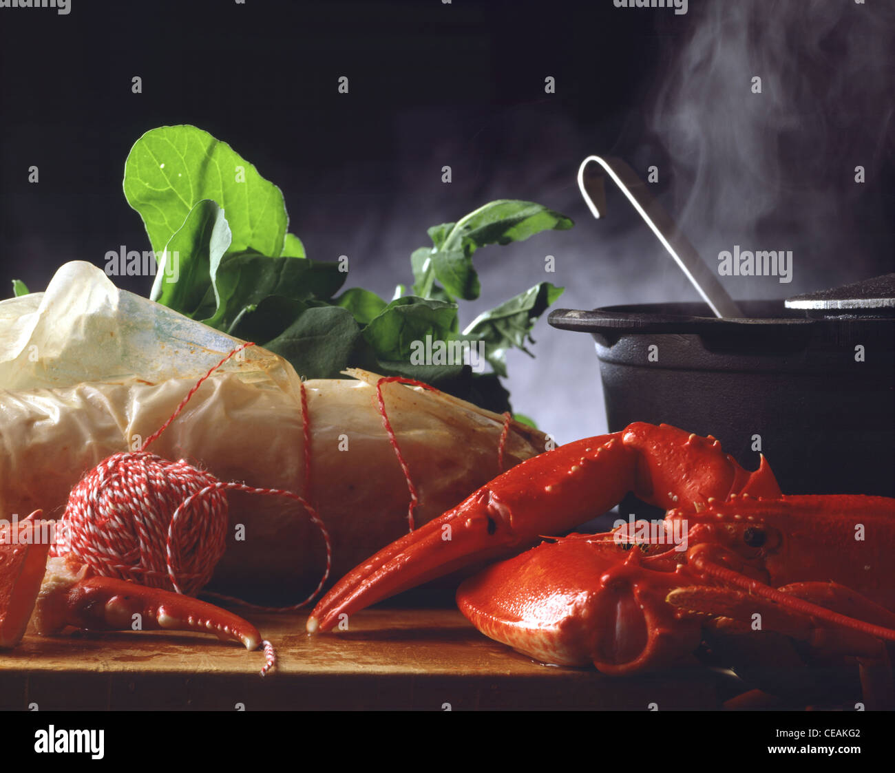 Still: Lobster, rabbit back in grease - proof - paper, cooking pot ...