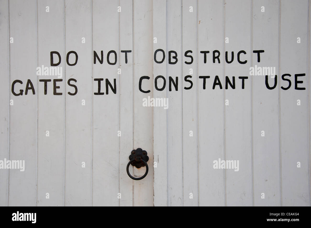 Wooden garage doors with do not obstruct sign Stock Photo - Alamy