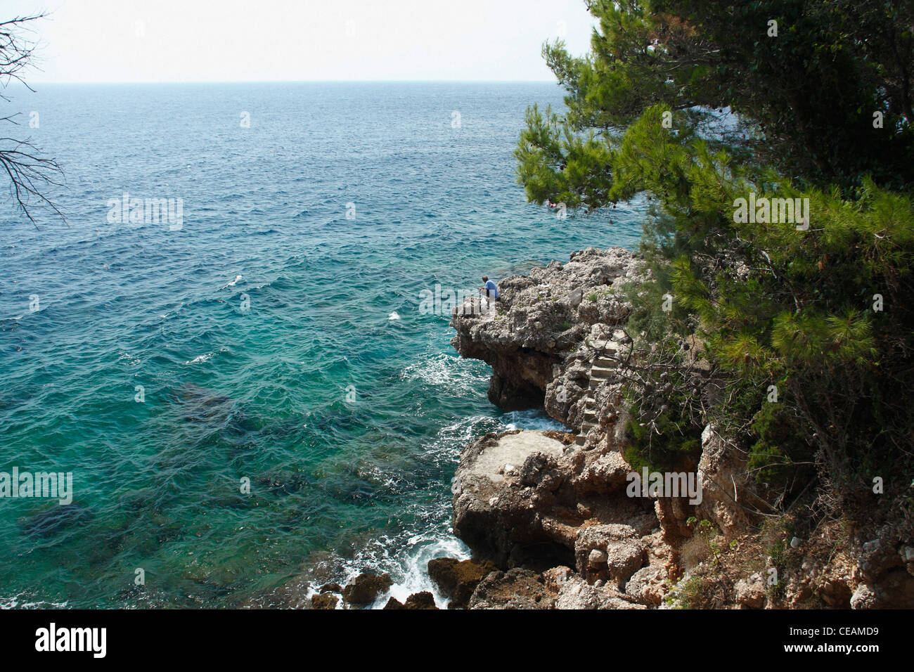 Fisherman on a rock in Dingac Borak, Peljesac peninsula, Croatia Stock ...