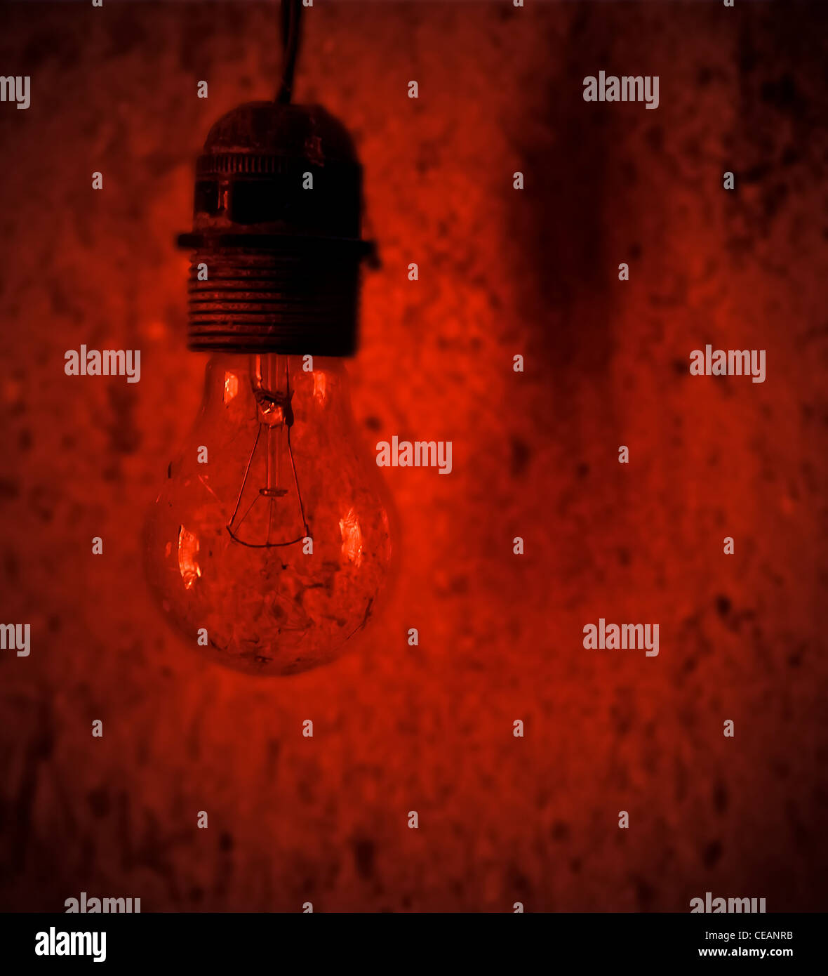 Close up of a Light Bulb in room with red light Stock Photo - Alamy