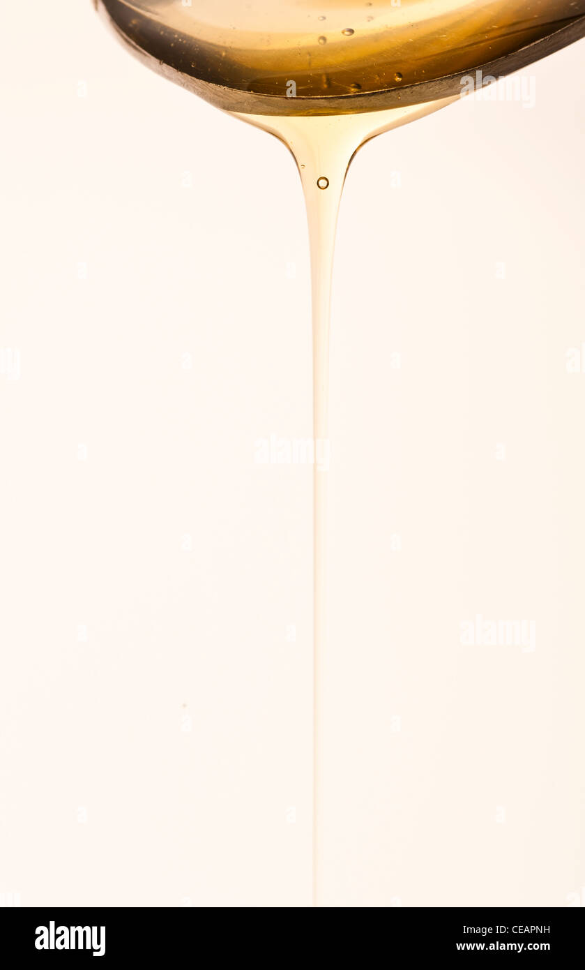 Honey dripping from spoon Stock Photo - Alamy
