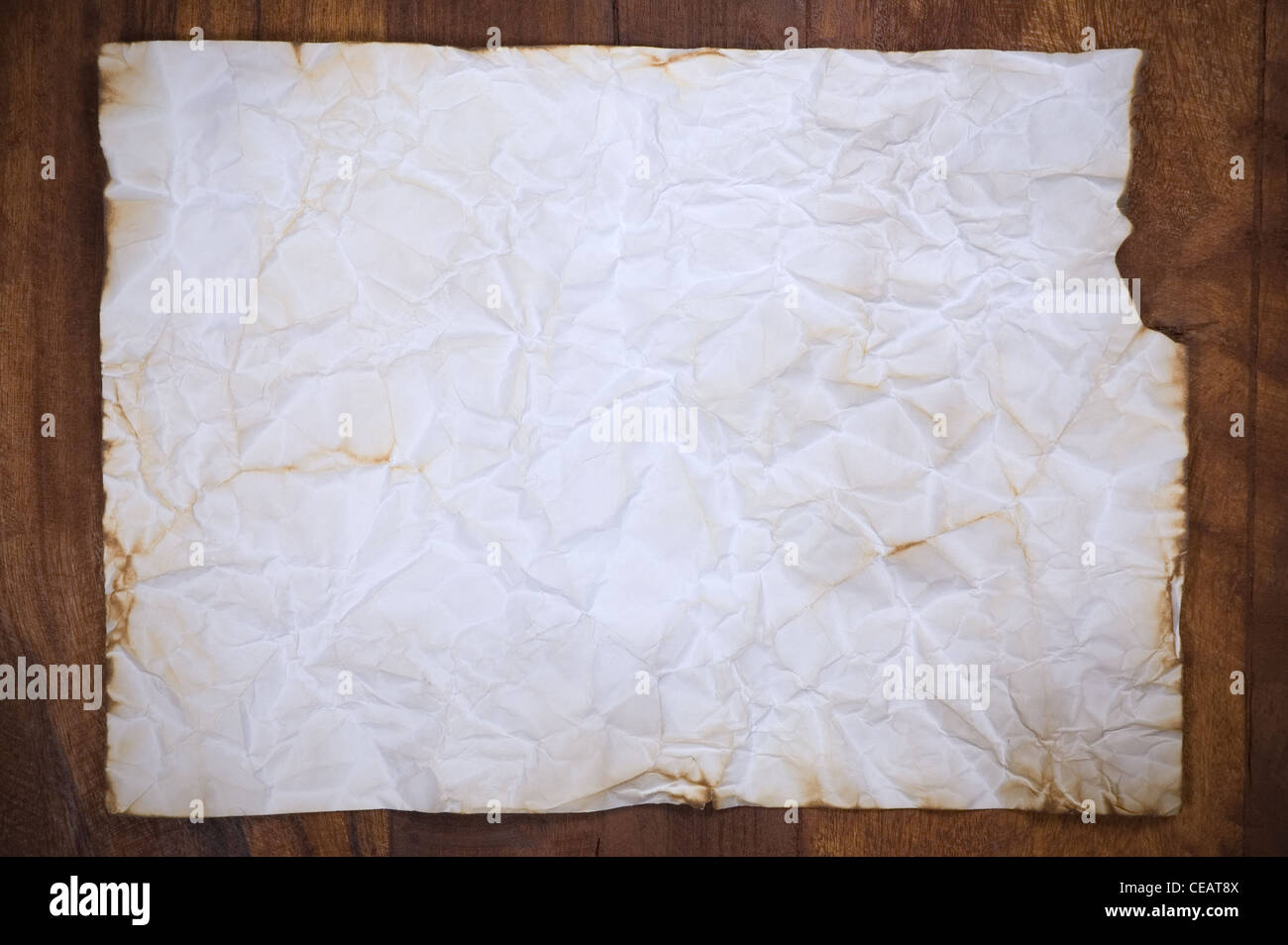 Old paper sheet on wooden background Stock Photo - Alamy
